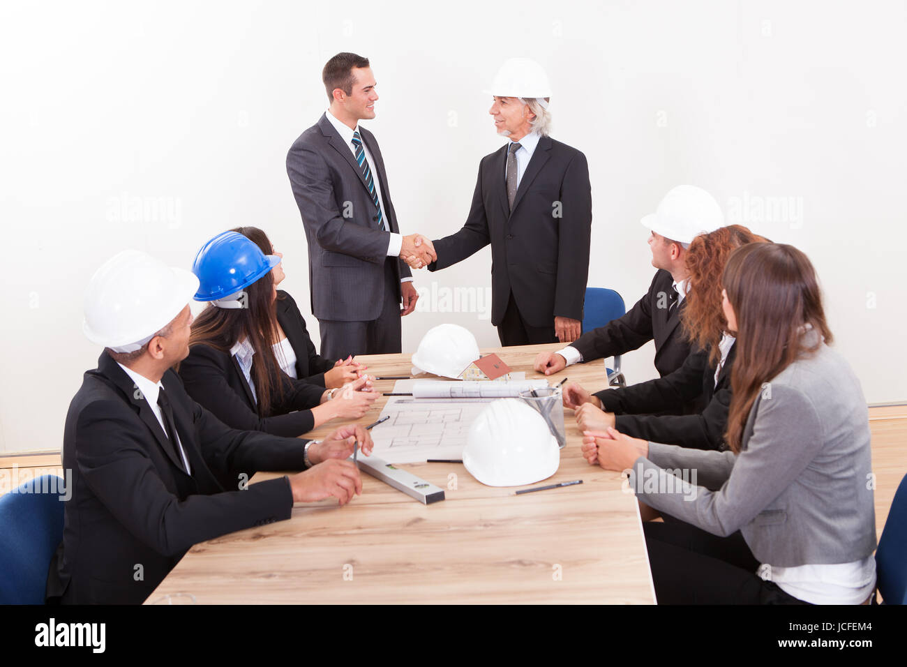 Businessman And Engineer Shaking Hands In Meeting Stock Photo - Alamy