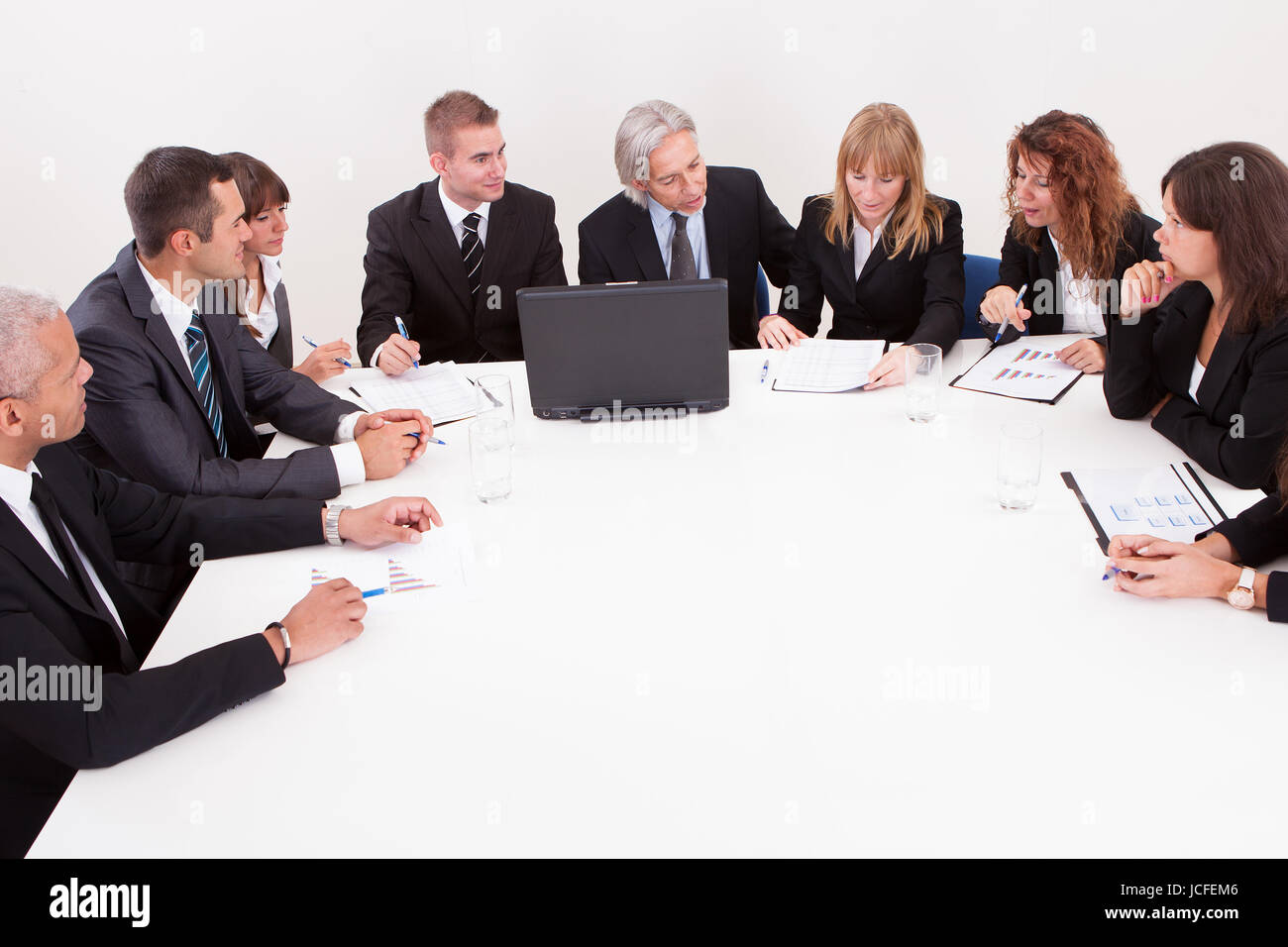 Businesspeople Sitting At Conference Table At The Meeting Stock Photo ...