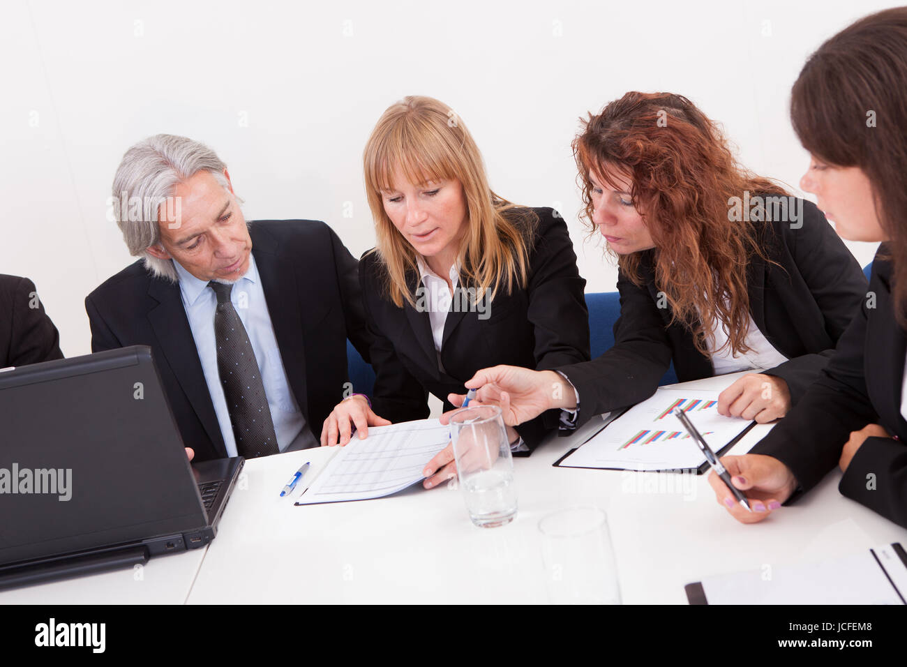 Businesspeople Sitting At Conference Table At The Meeting Stock Photo ...