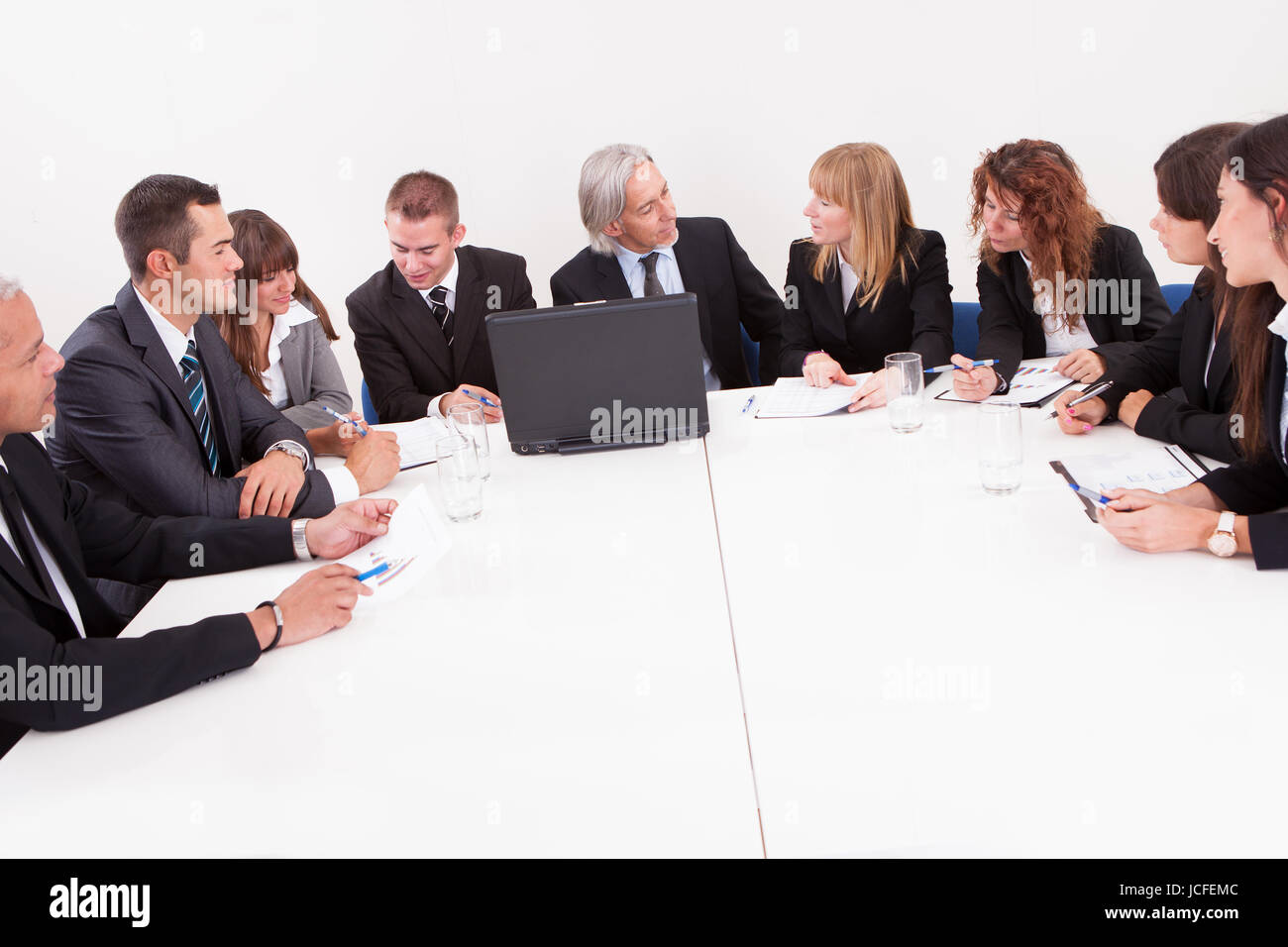Businesspeople Sitting At Conference Table At The Meeting Stock Photo ...