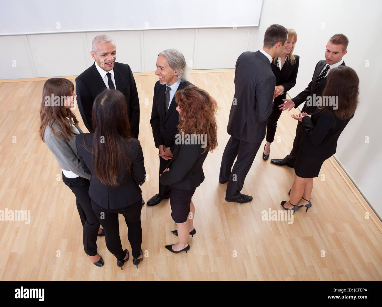 High angle view of professional business people standing around in ...