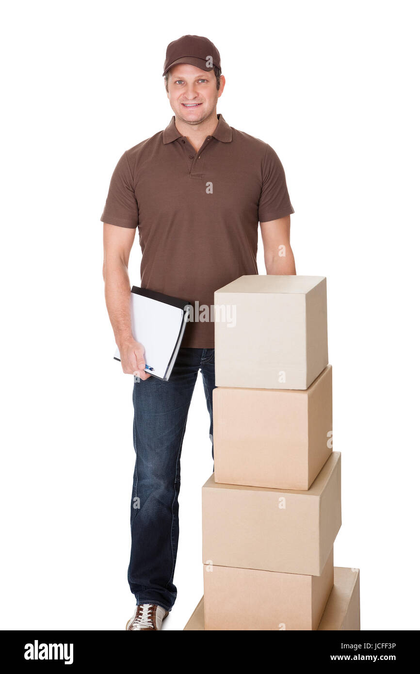 Portrait of delivery man doing paperwork. Isolated on white background ...