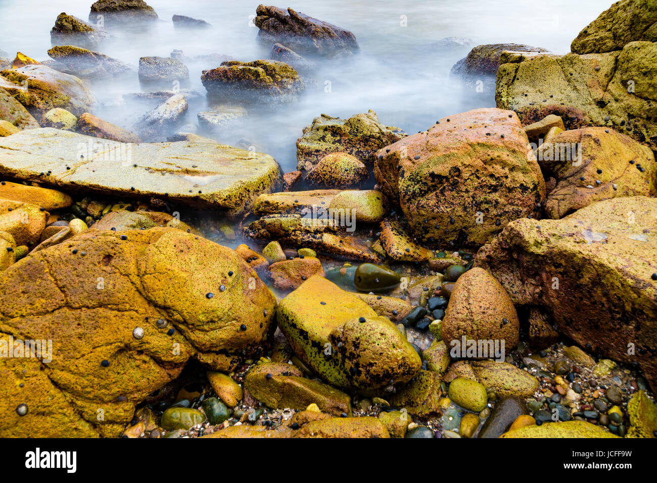 Colourful rocks and water at Diamond Head coast, Australia Stock Photo ...