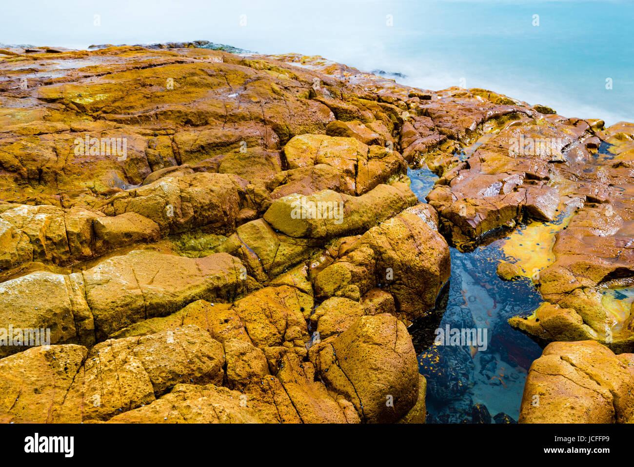 Colourful rocks and water at Diamond Head coast, Australia Stock Photo ...