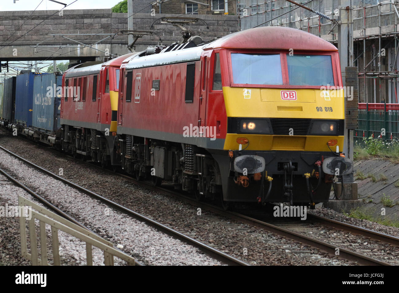 Two red electric locomotives operated by DB Cargo with a container ...