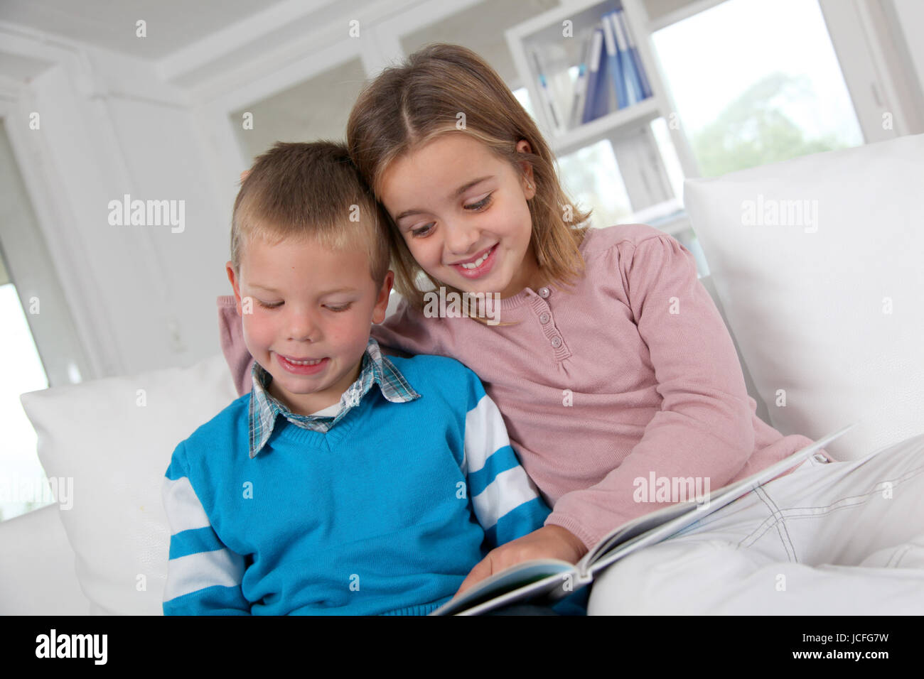 Children reading book at home Stock Photo - Alamy