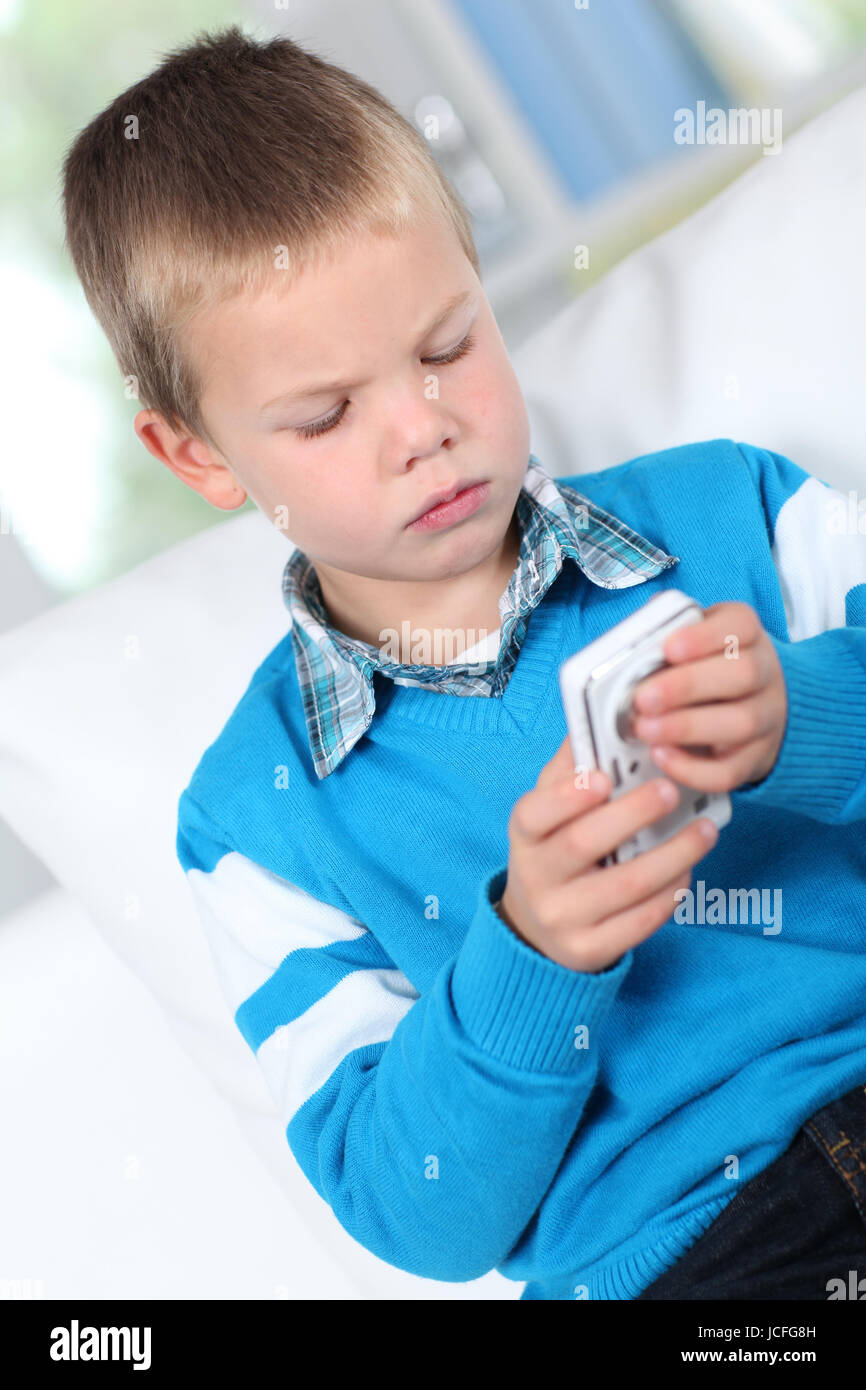 Little boy playing with smartphone Stock Photo - Alamy