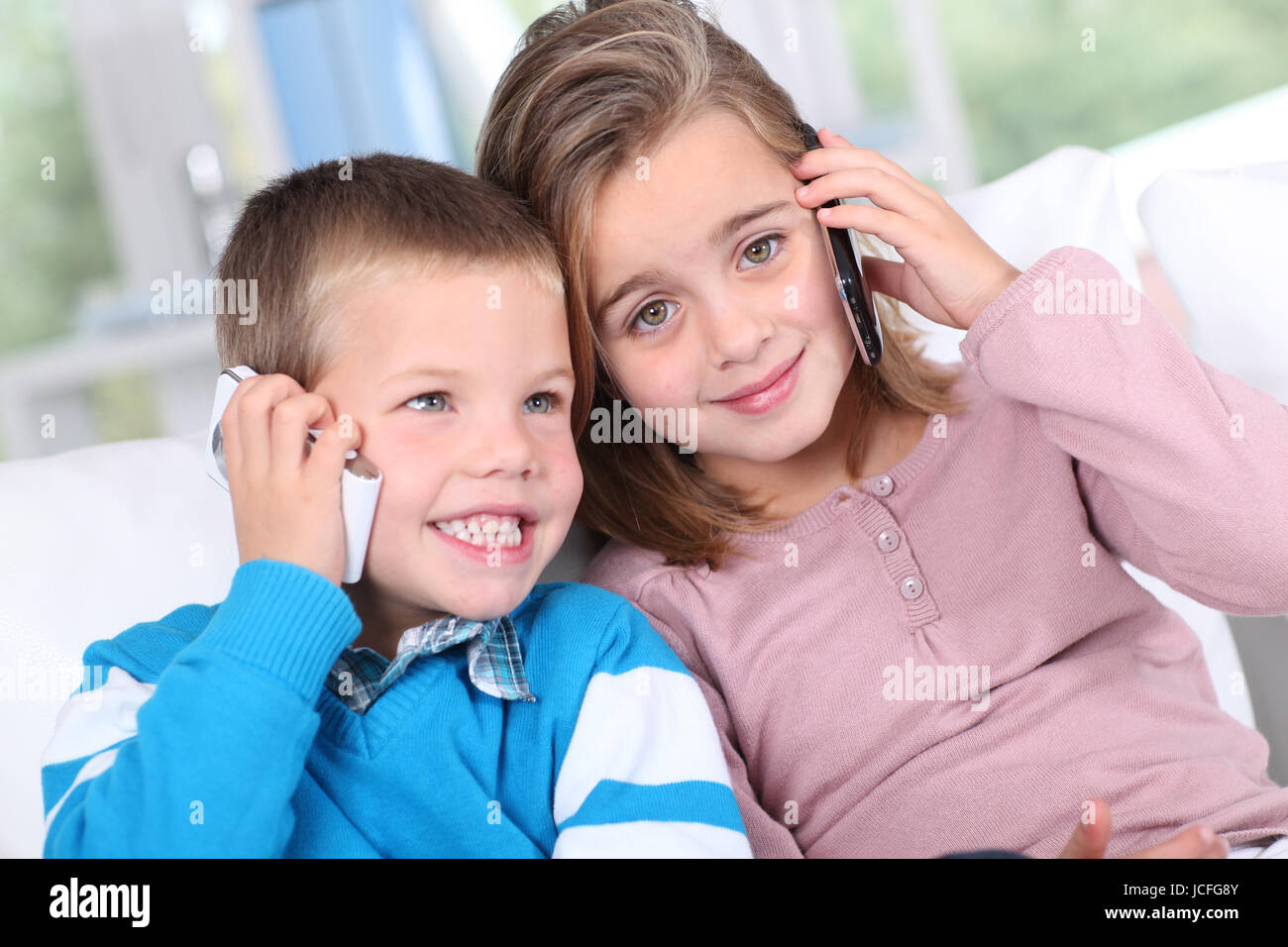 Portrait of kids talking on mobile phone Stock Photo - Alamy