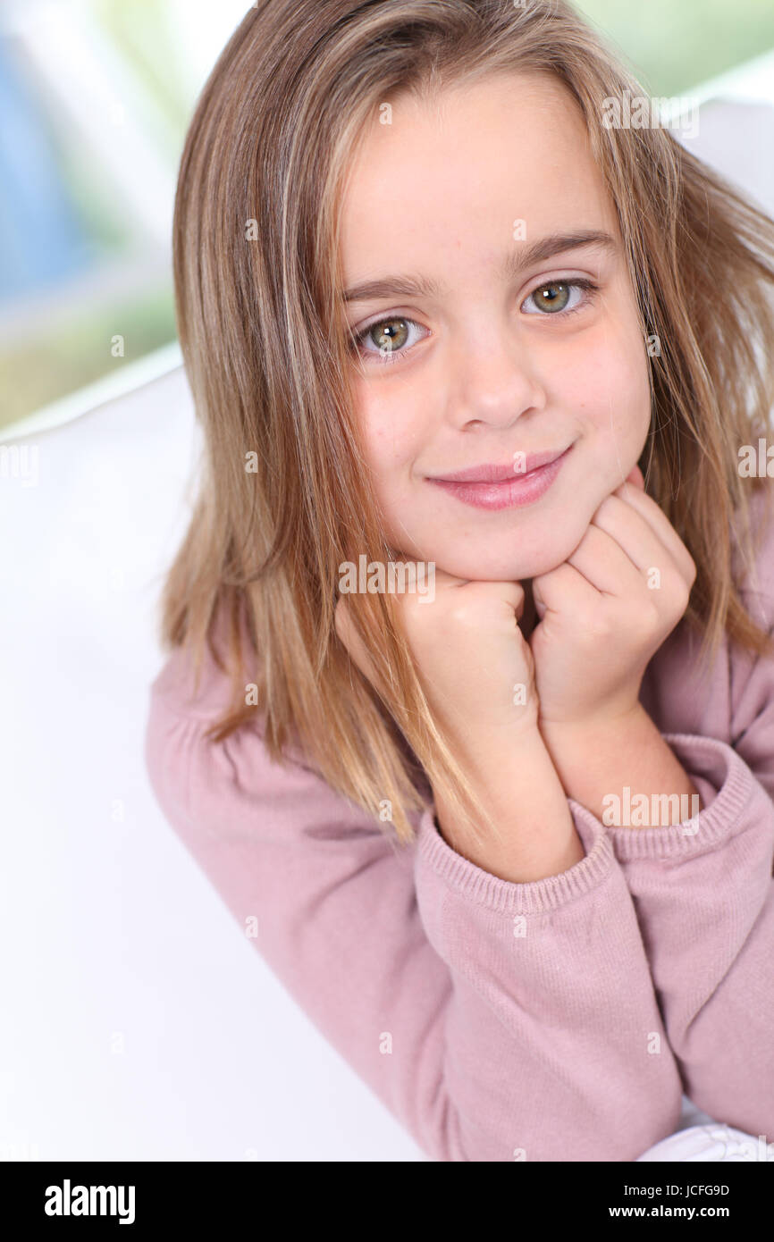 Portrait of cute little girl with hands on chin Stock Photo - Alamy