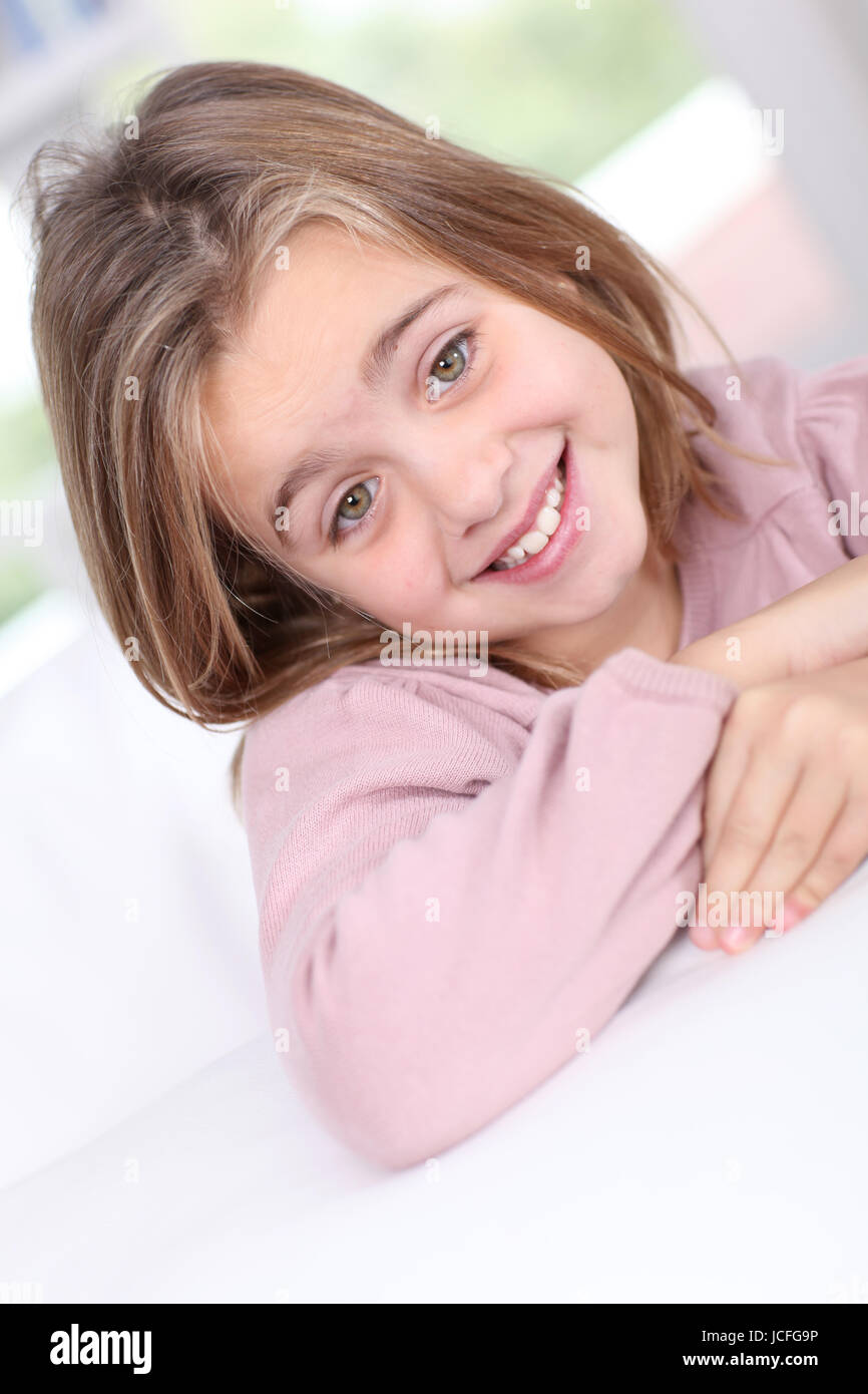 Portrait of cute little girl with hands on chin Stock Photo - Alamy