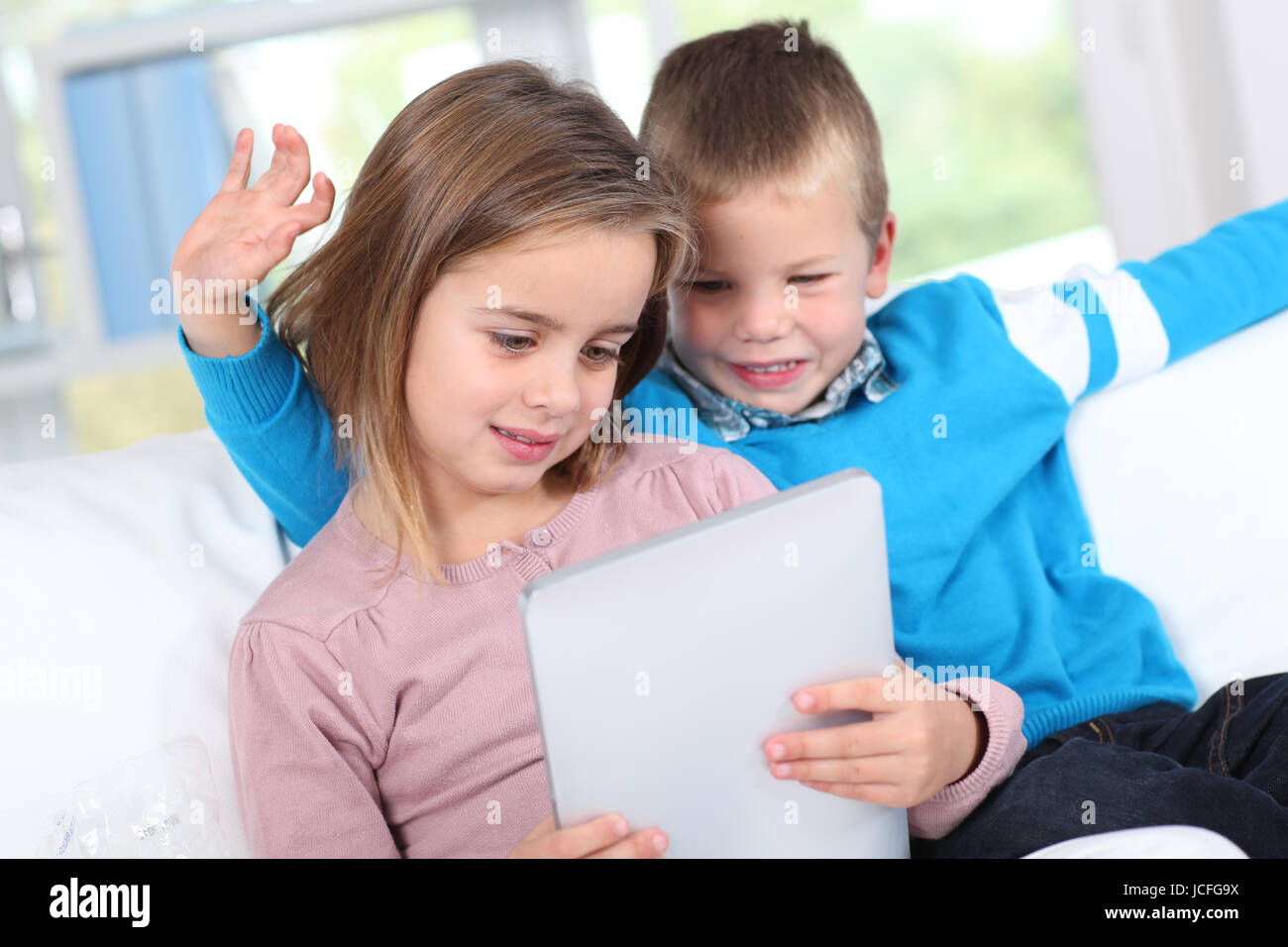 Children using electronic tablet at home Stock Photo - Alamy