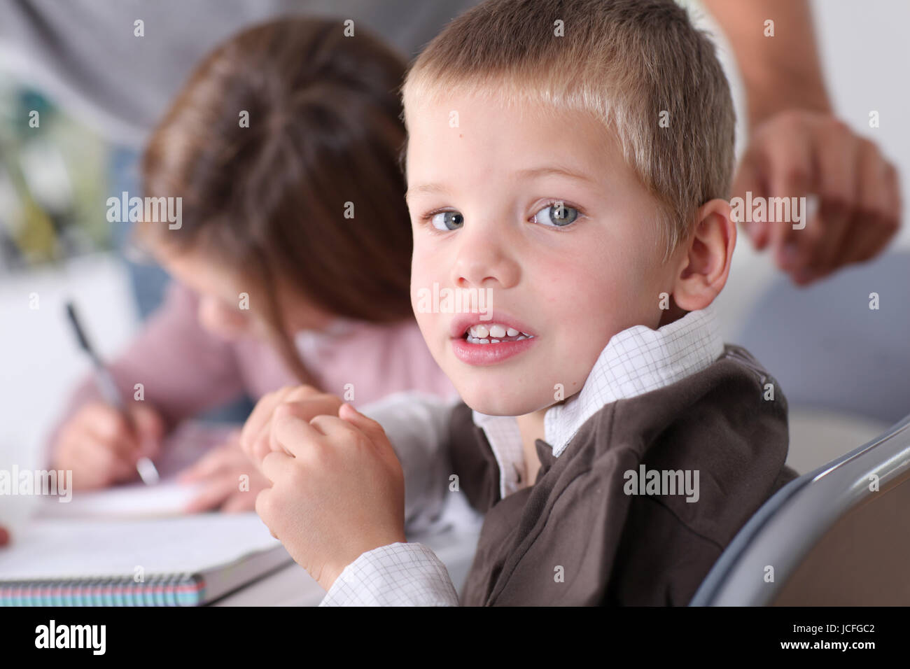 Kids at school doing their homework Stock Photo - Alamy