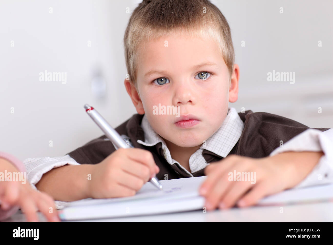 Portrait of little boy doing homework Stock Photo - Alamy