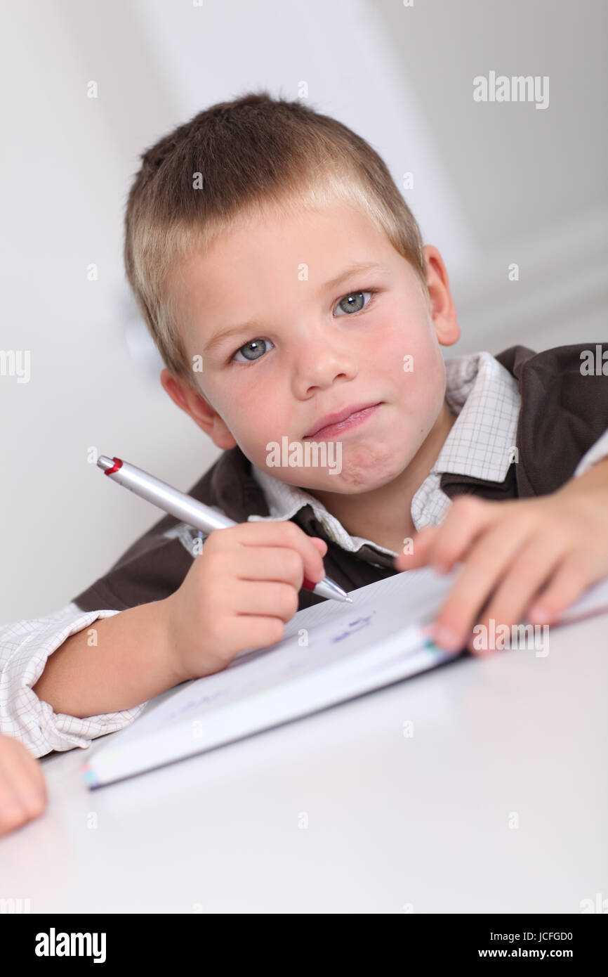 Portrait of little boy doing homework Stock Photo - Alamy