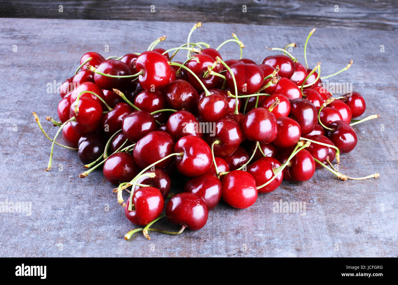 Cherry basket / Sweet cherry background/ cherry with leaf on grey Stock ...