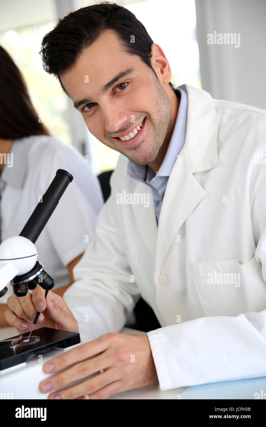 Doctor in biology working on microscope Stock Photo - Alamy