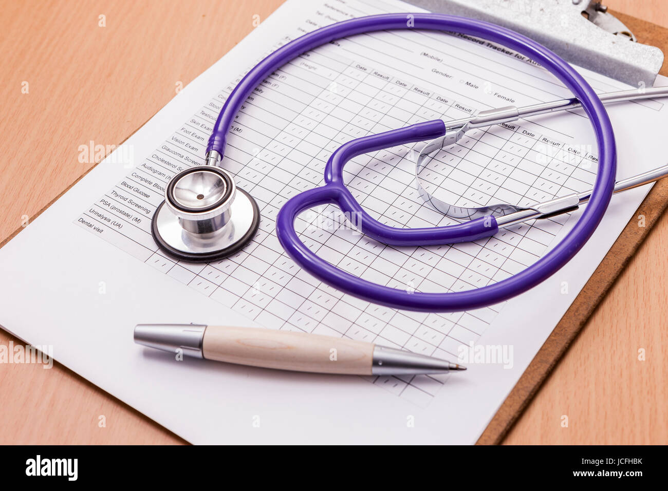 A close up of s stethoscope and an ink pen on top of a medical form on ...