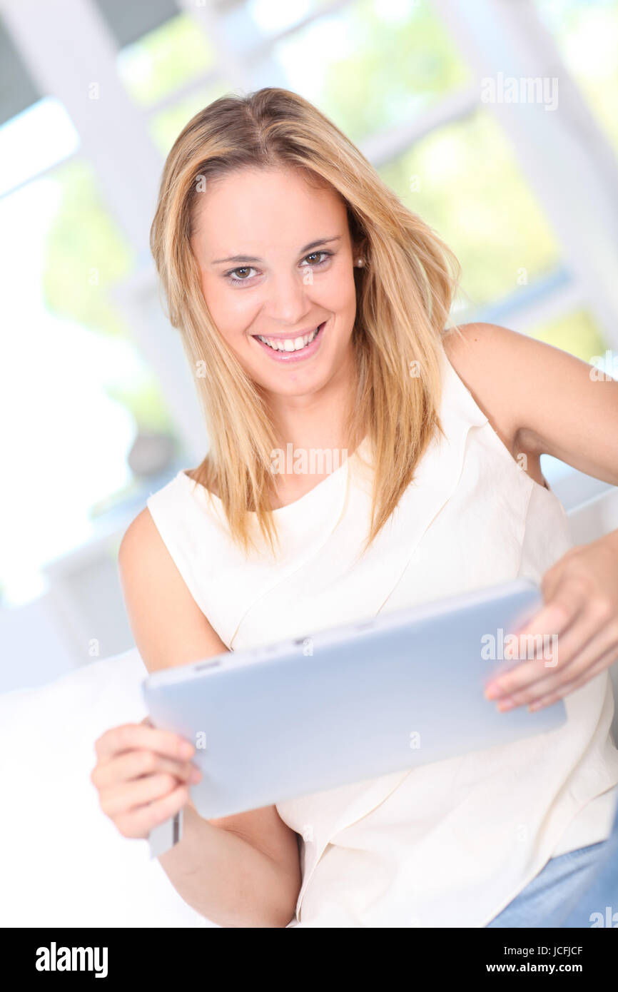 Young woman at home using electronic tablet Stock Photo - Alamy