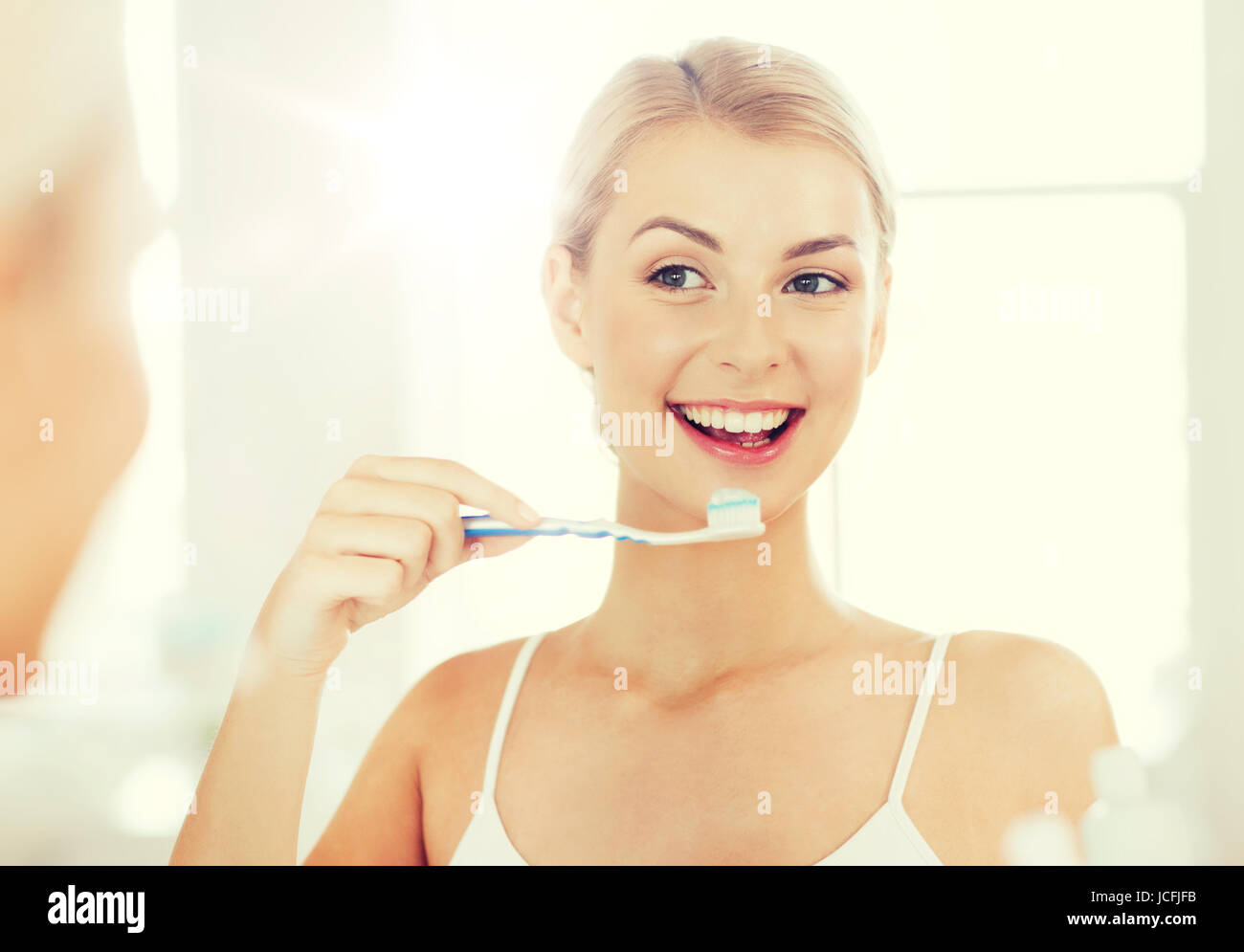 Woman brushing teeth bathroom hi-res stock photography and images - Alamy