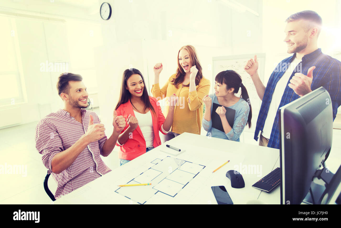 happy creative team celebrating success at office Stock Photo - Alamy