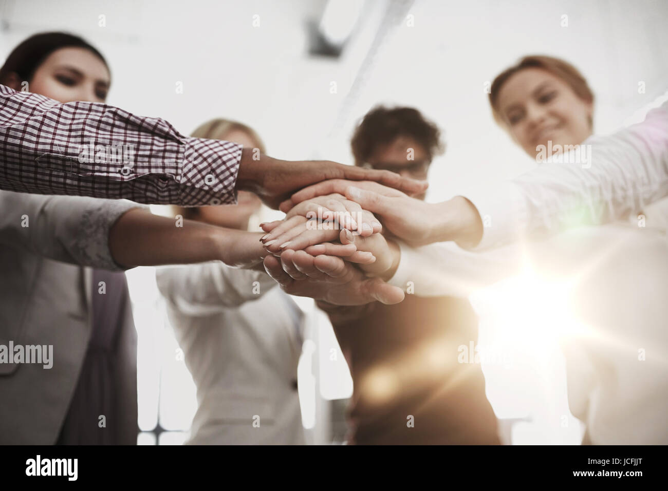 happy business team with hands on top at office Stock Photo - Alamy
