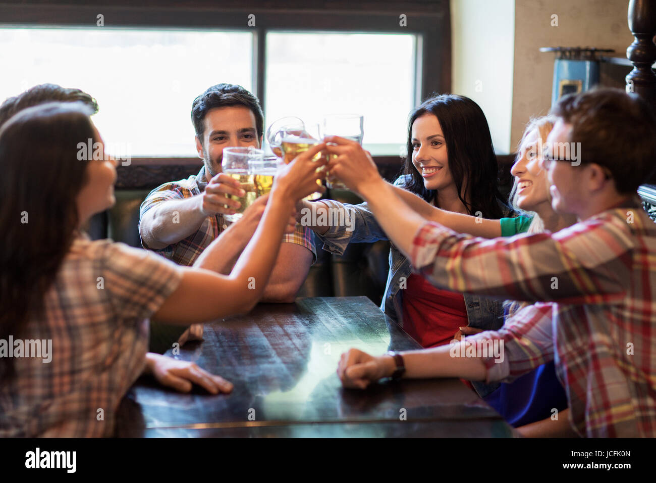 happy friends drinking beer at bar or pub Stock Photo - Alamy