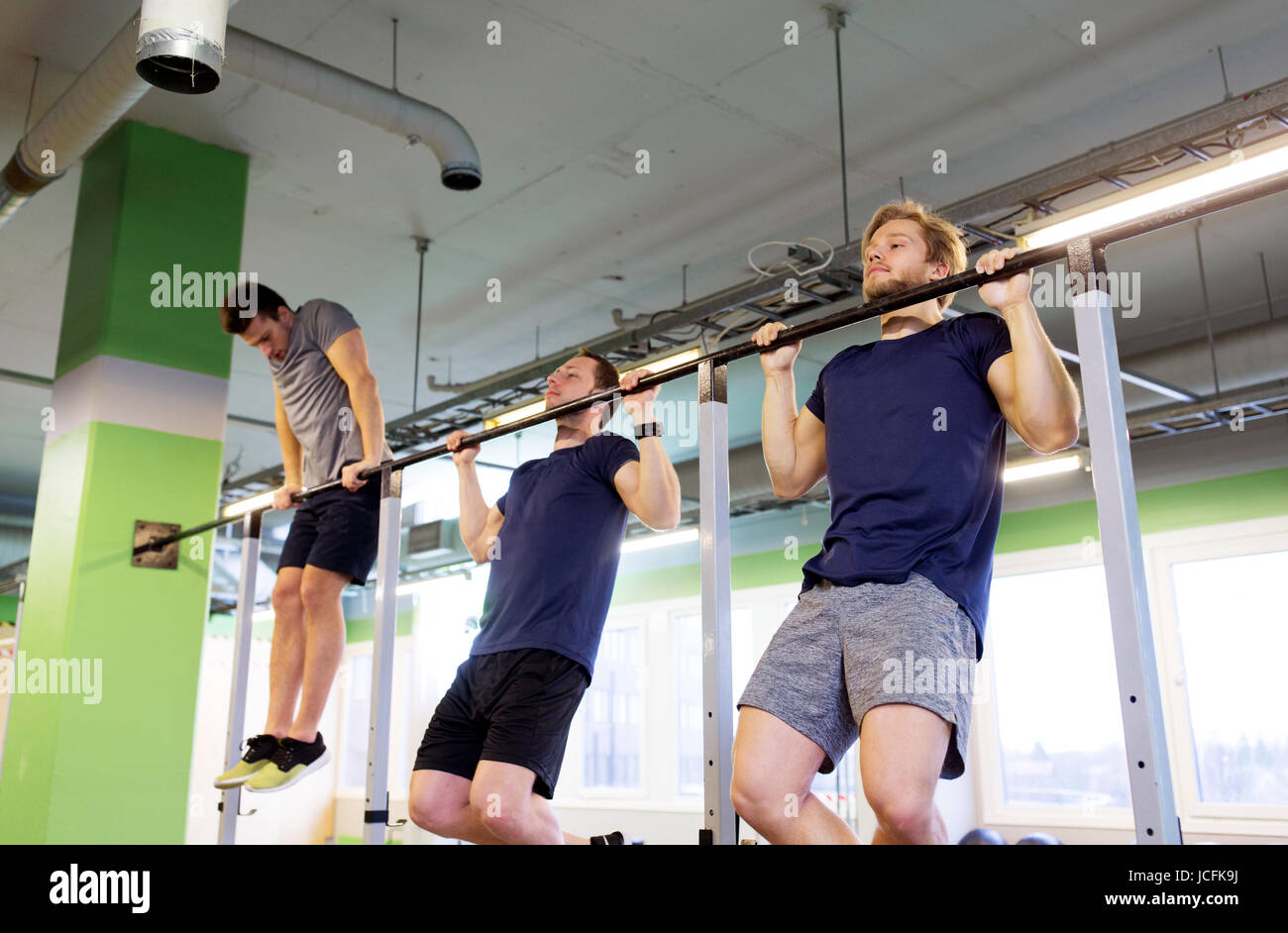 group of young men doing pull-ups in gym Stock Photo - Alamy