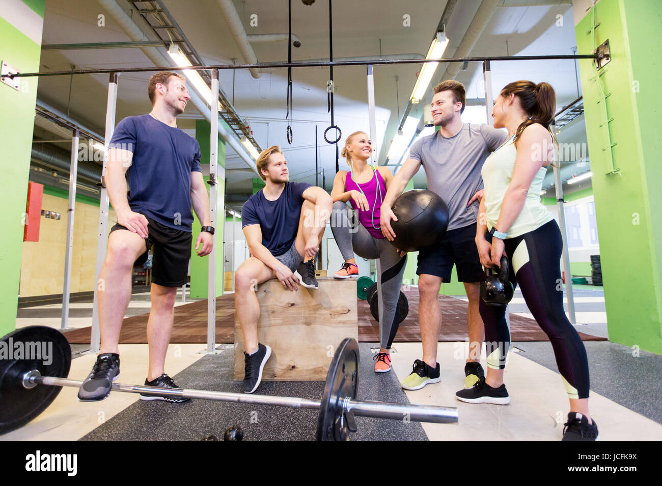group of friends with sports equipment in gym Stock Photo - Alamy