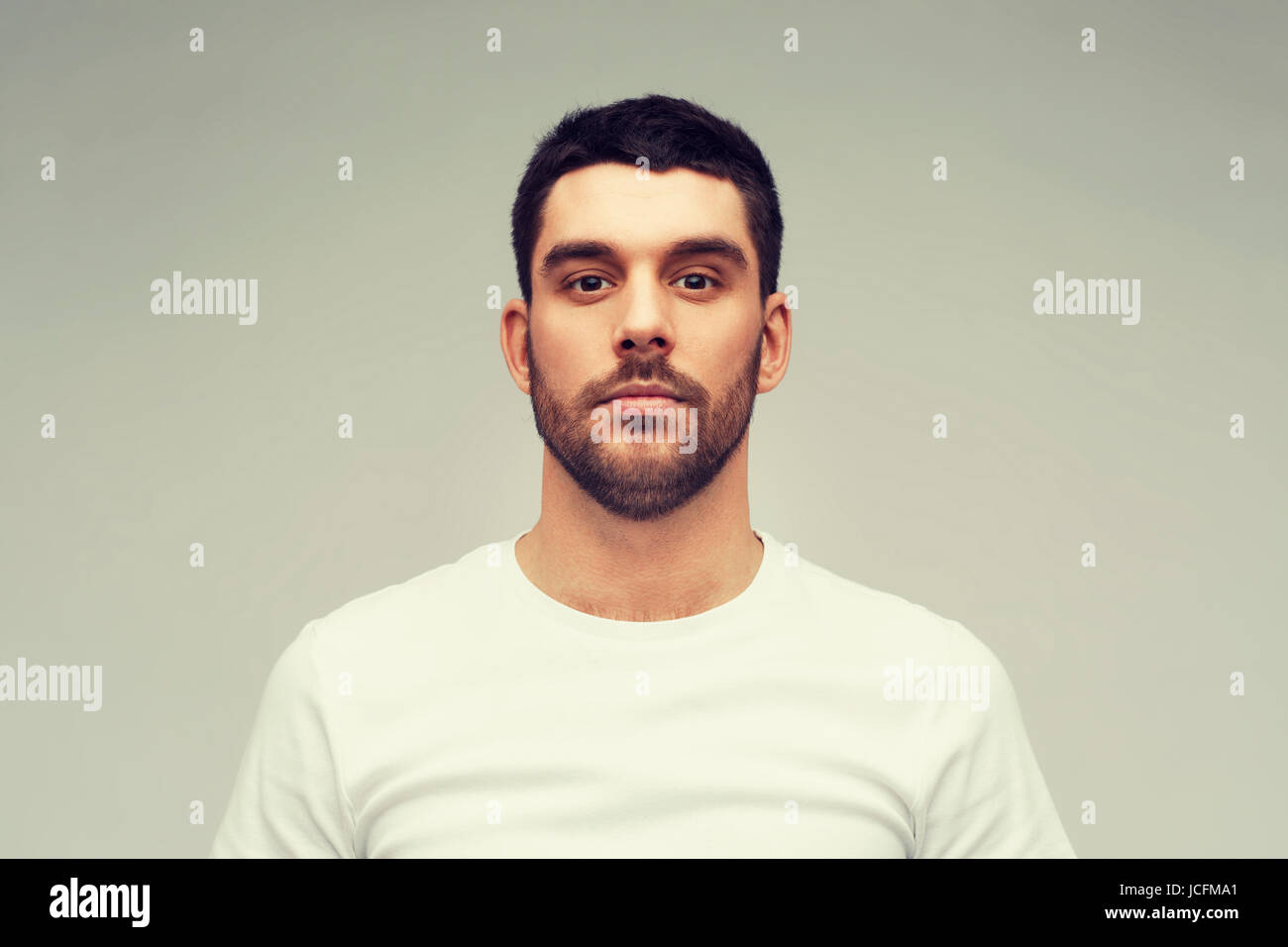 young man portrait over gray background Stock Photo - Alamy