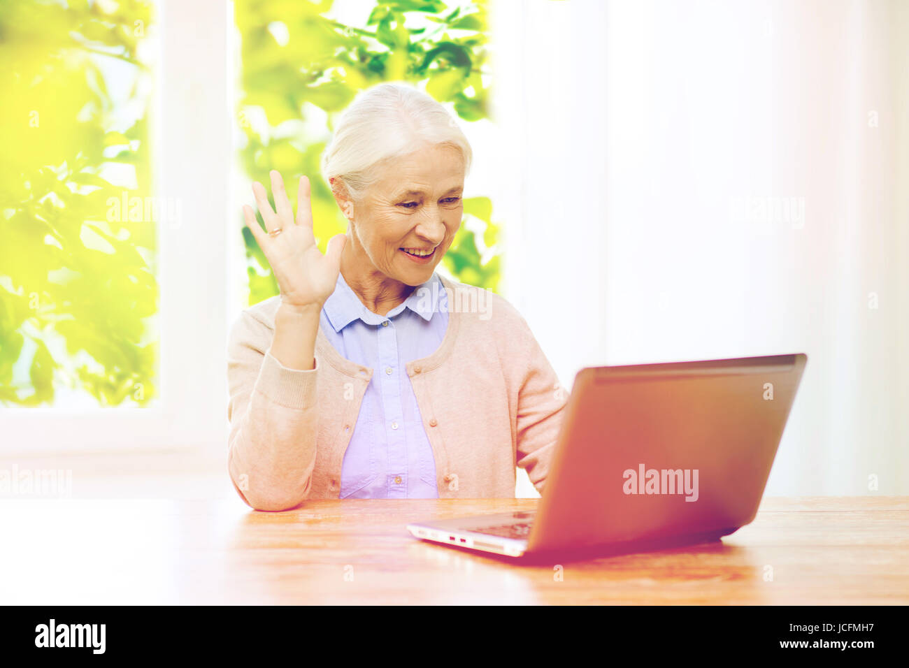 senior woman with laptop having video chat at home Stock Photo - Alamy