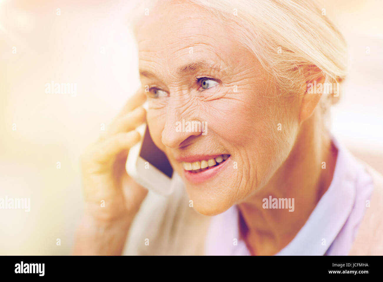 senior woman with smartphone calling at home Stock Photo - Alamy
