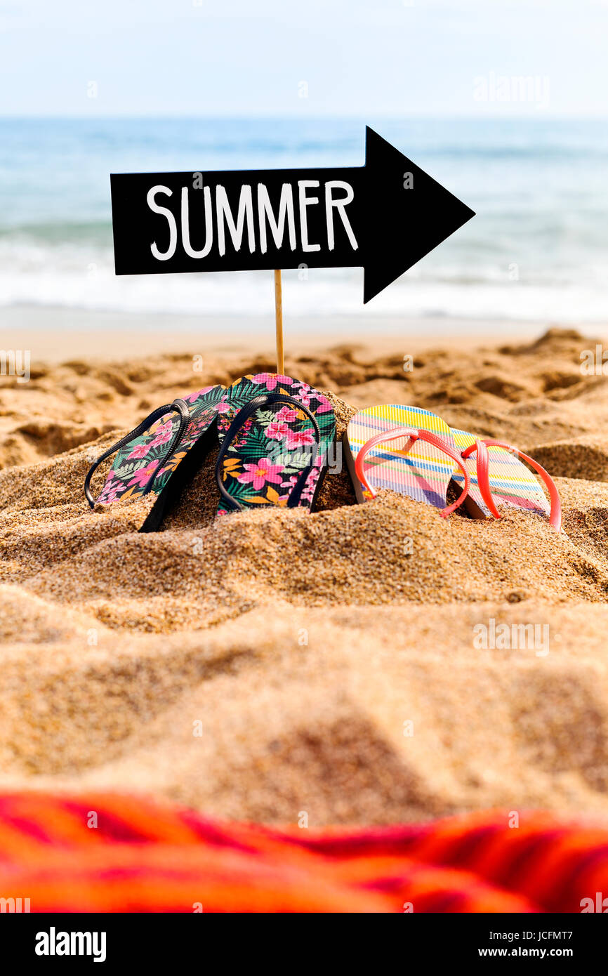 closeup of a black signboard in the shape of an arrow sign with the ...