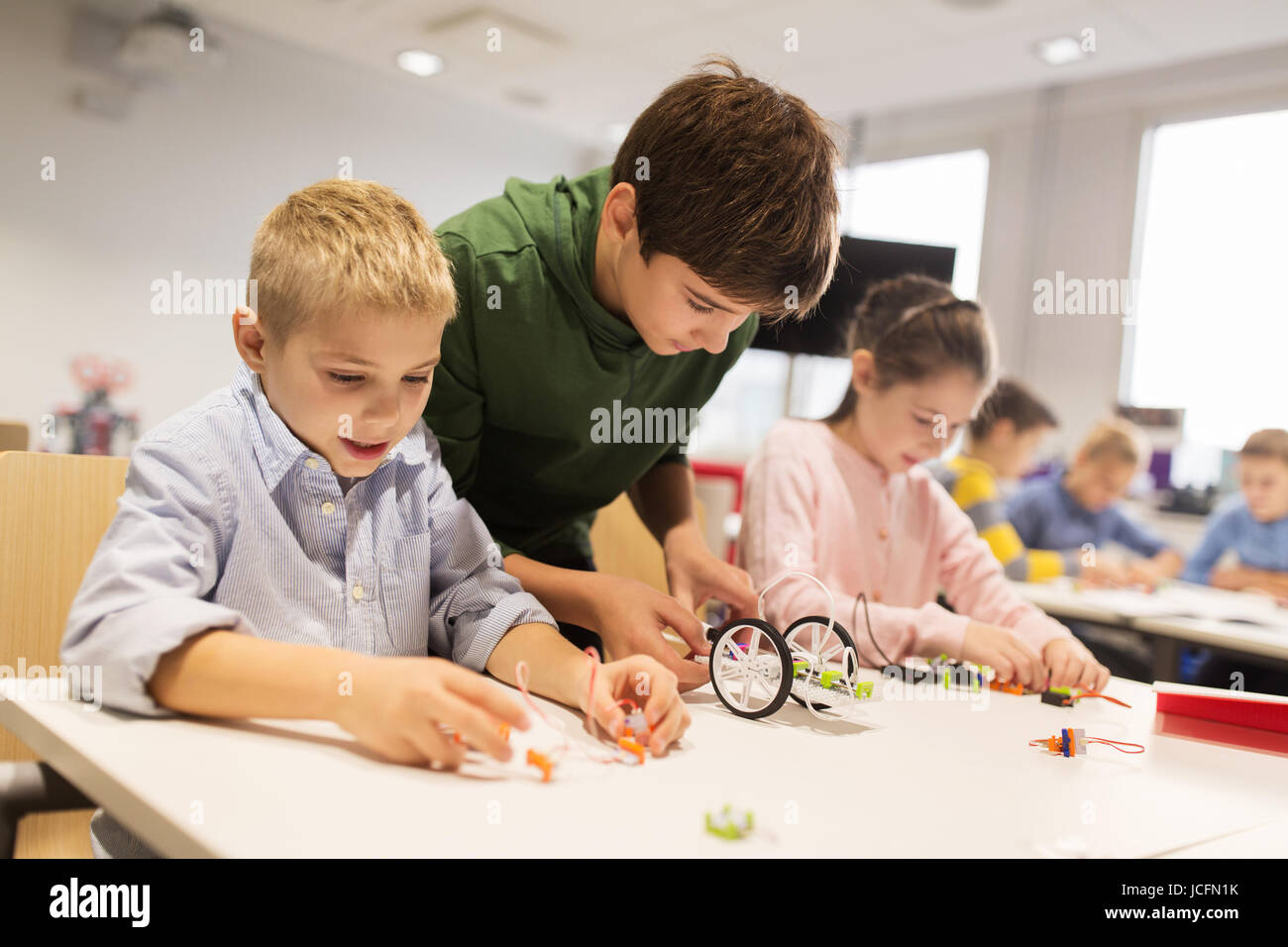 happy children building robots at robotics school Stock Photo - Alamy