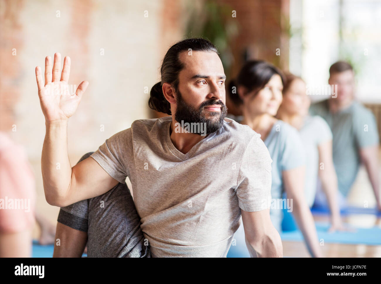 man with group of people doing yoga at studio Stock Photo - Alamy