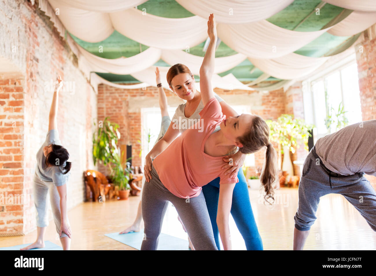 group of people doing yoga exercises at studio Stock Photo - Alamy