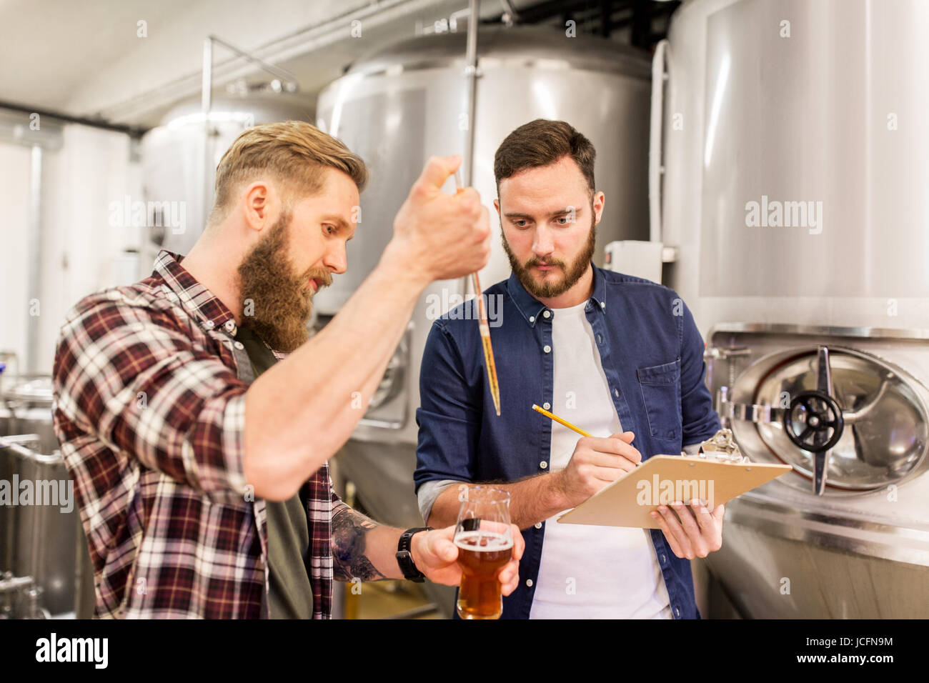 men with pipette testing craft beer at brewery Stock Photo - Alamy