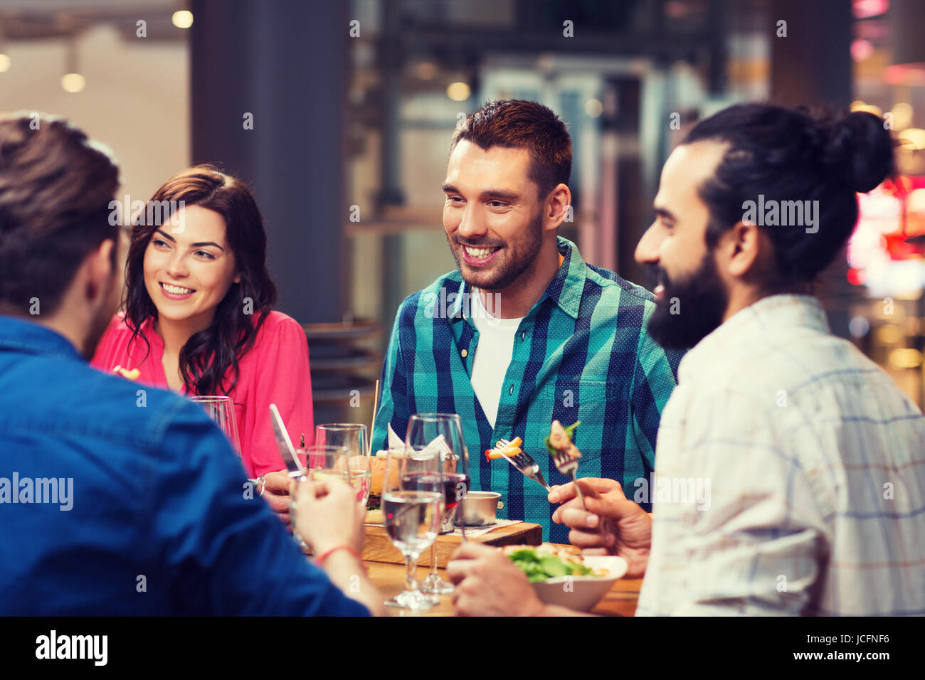 happy friends having dinner at restaurant Stock Photo - Alamy