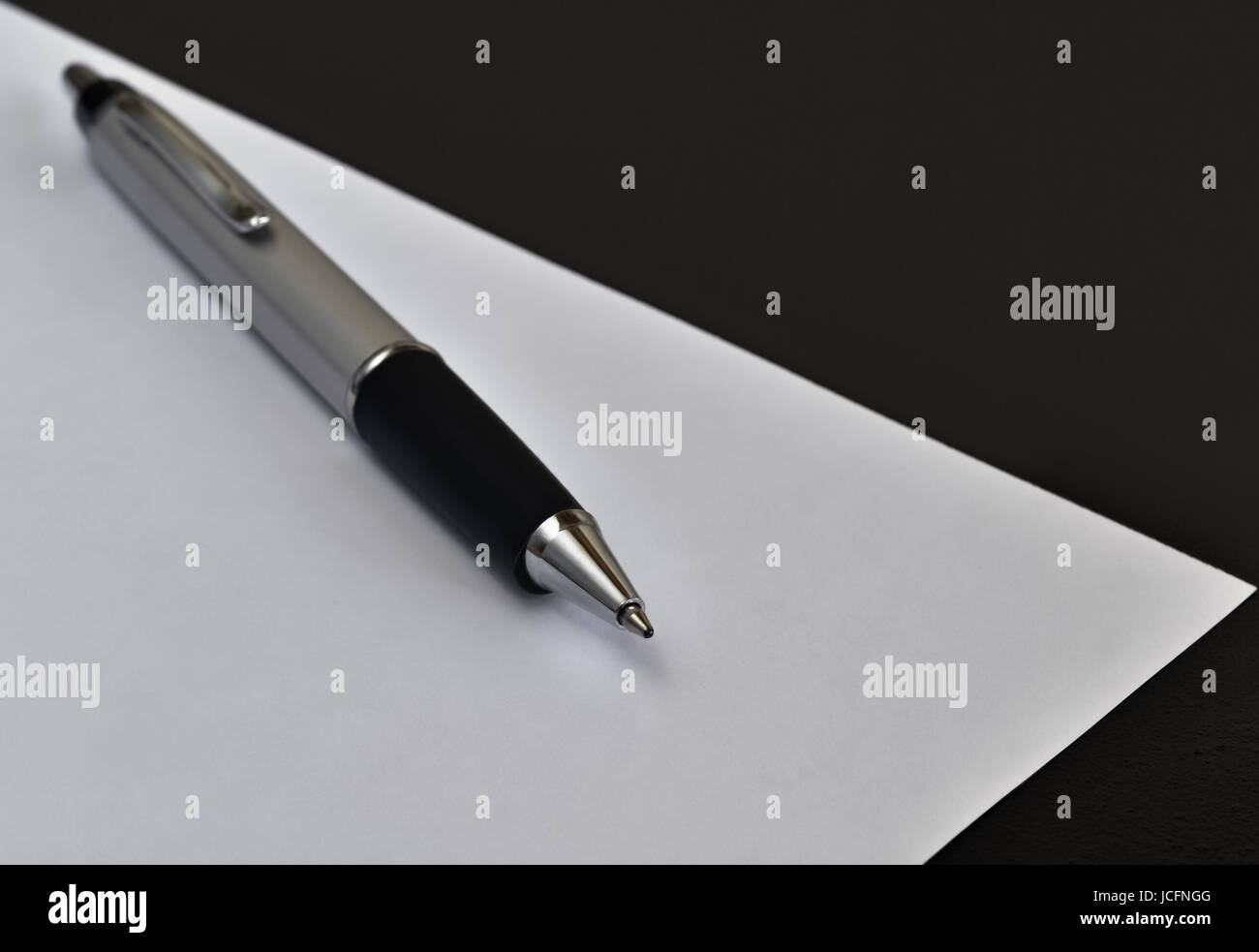 Closeup of a pen and part of a blank paper Stock Photo - Alamy