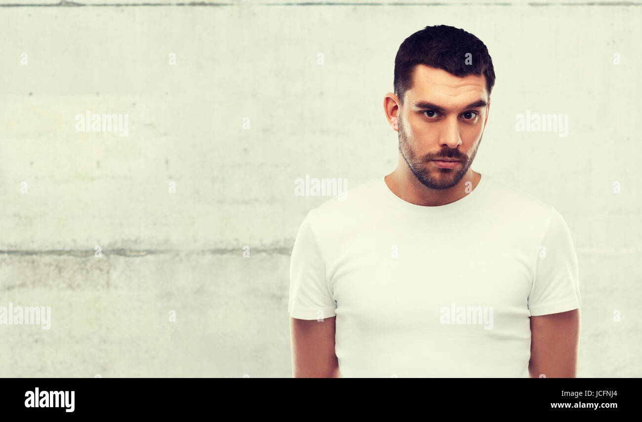 young man portrait over gray wall background Stock Photo - Alamy