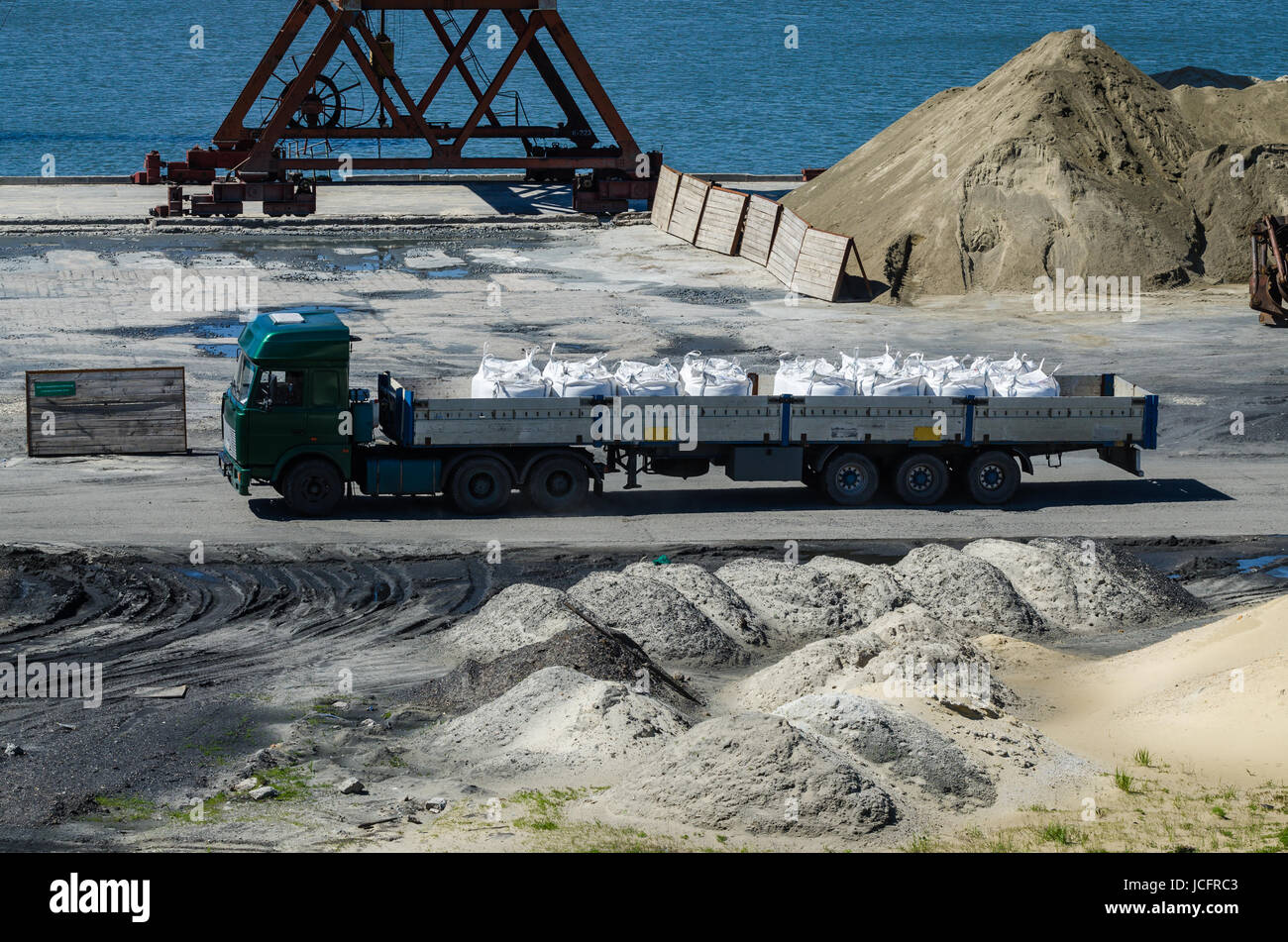 Crane in river port. Heavy cranes unloading metal to import. Steel ...