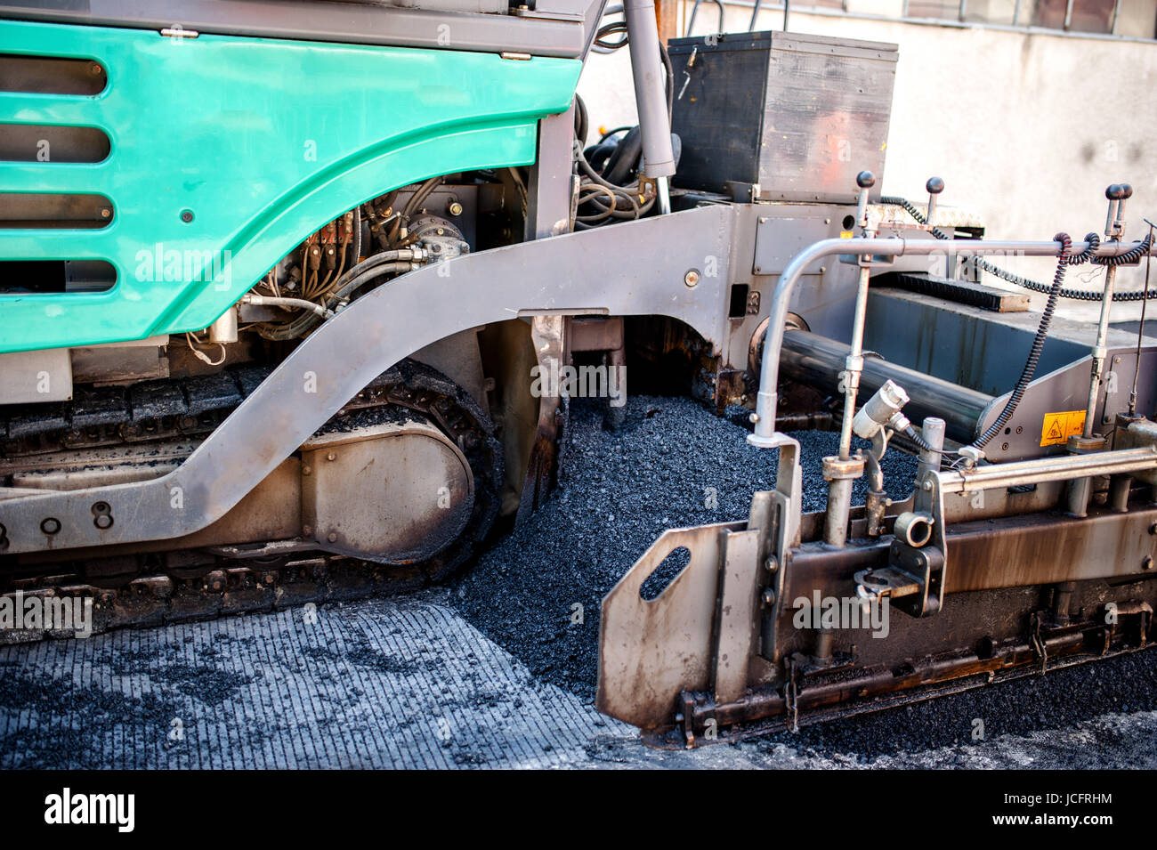 Industrial pavement truck or machine laying fresh bitumen and asphalt ...
