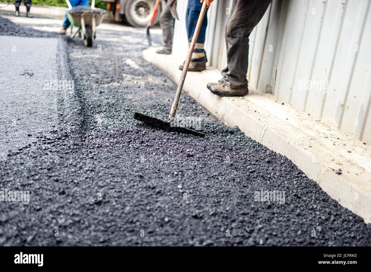 worker with special tool working with fresh asphalt and bitumen Stock ...