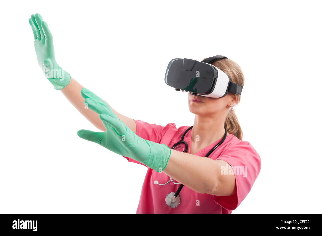 Female nurse wearing virtual reality goggles gesturing isolated on ...