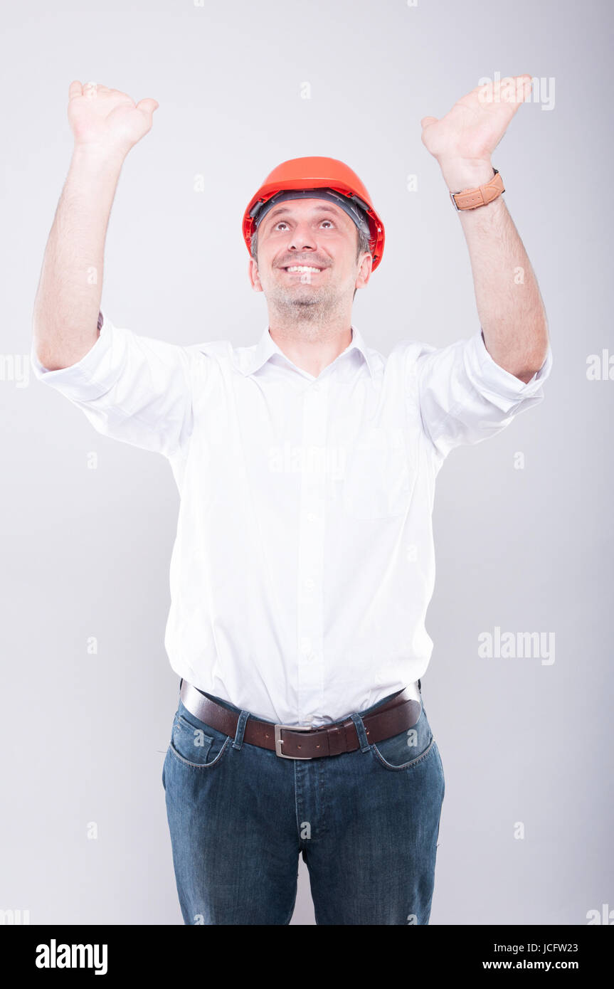 Portrait of architect posing holding something heavy with both hands on ...