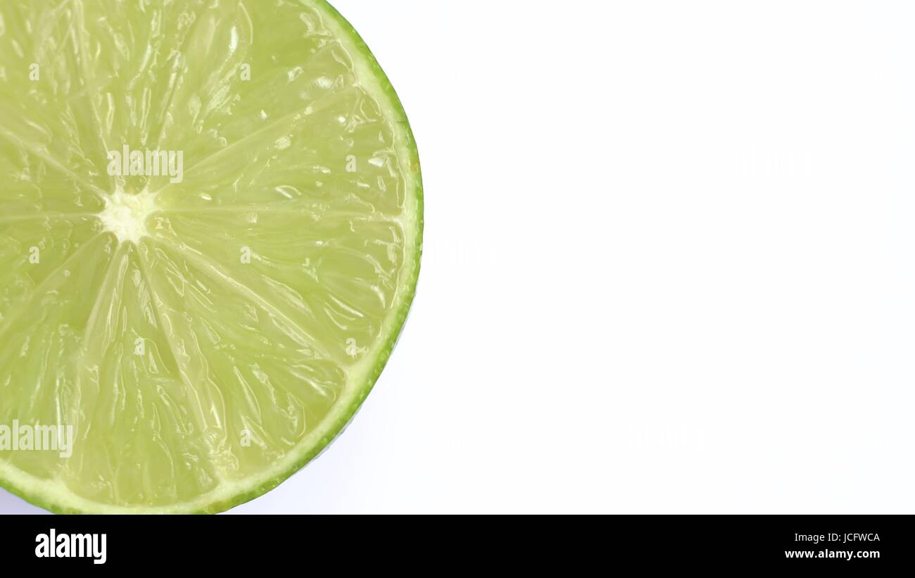 The cut green lime slice on a white background Stock Photo - Alamy