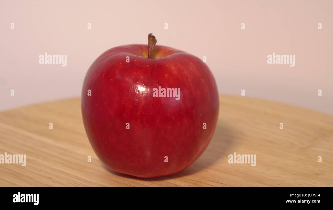One bright tasty red apple on wooden table Stock Photo - Alamy
