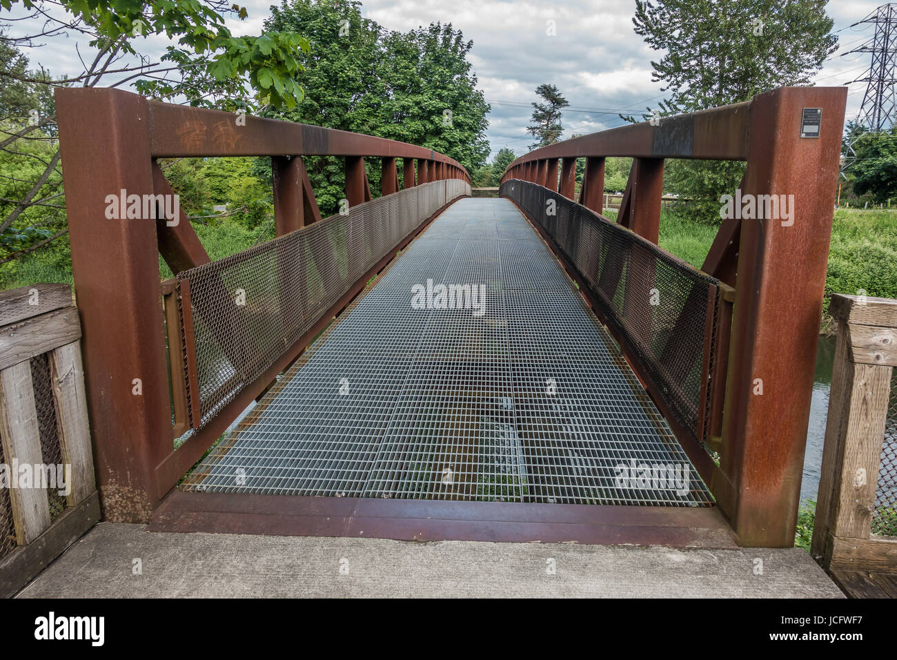 A rusted metal bridge spans the Green River in Kent, Washington Stock ...
