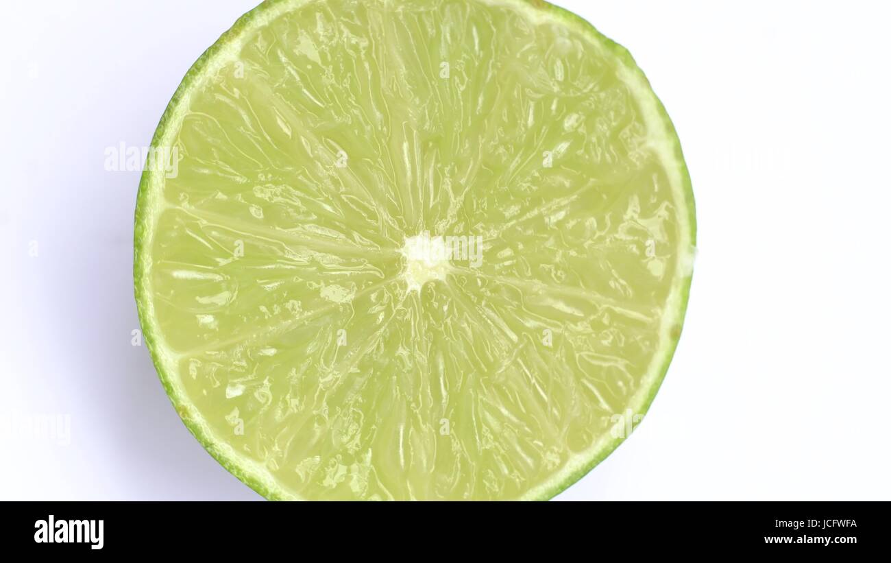 The cut green lime slice on a white background Stock Photo - Alamy
