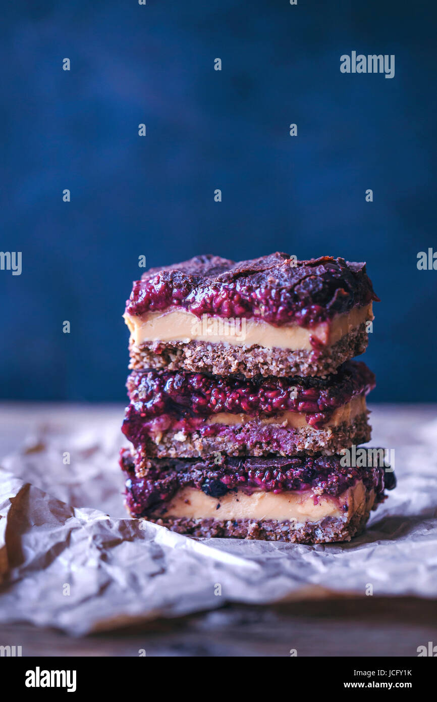 Stack of raw peanut butter and raspberry chia jam bars Stock Photo - Alamy