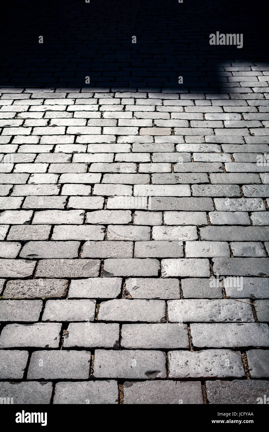 Granite blocks in the walkway and a shadow Stock Photo - Alamy